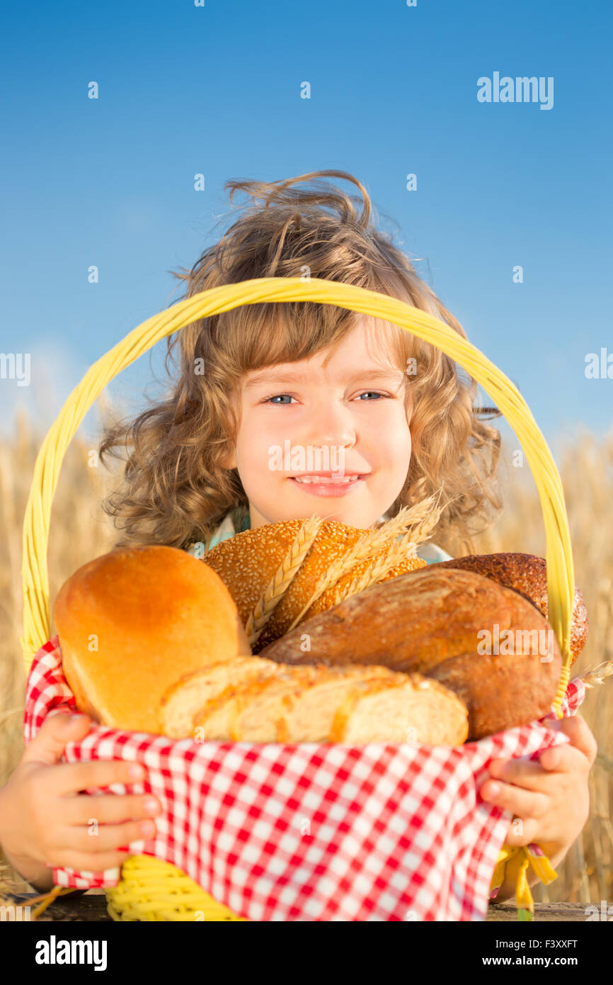 Happy child with bread in basket Stock Photo - Alamy