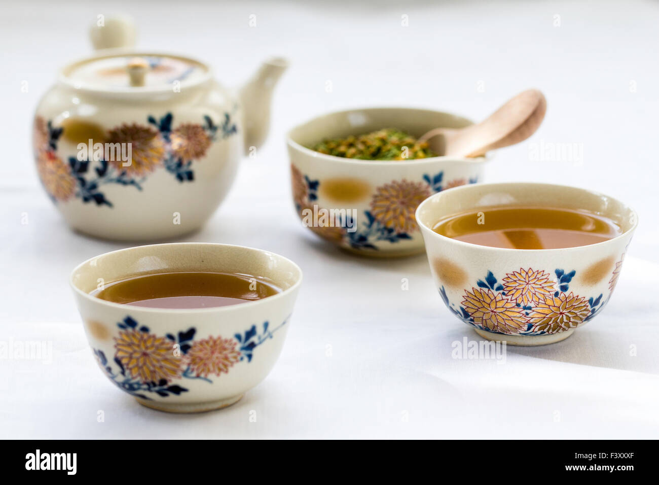 Japanese Chrysanthemum decorated tea set. Teapot, two handless cups ...