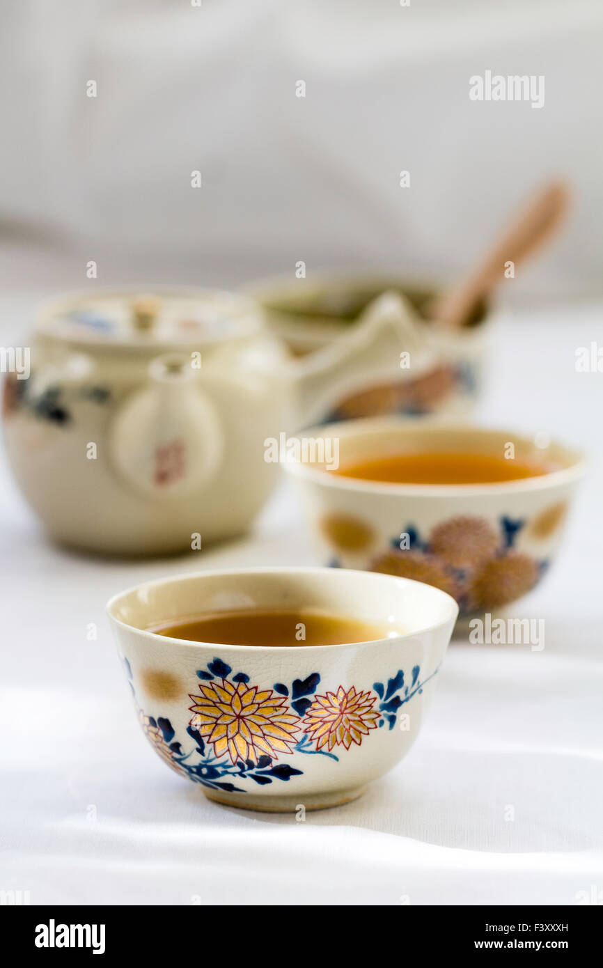 Japanese Chrysanthemum decorated tea set. Teapot, two handless cups ...