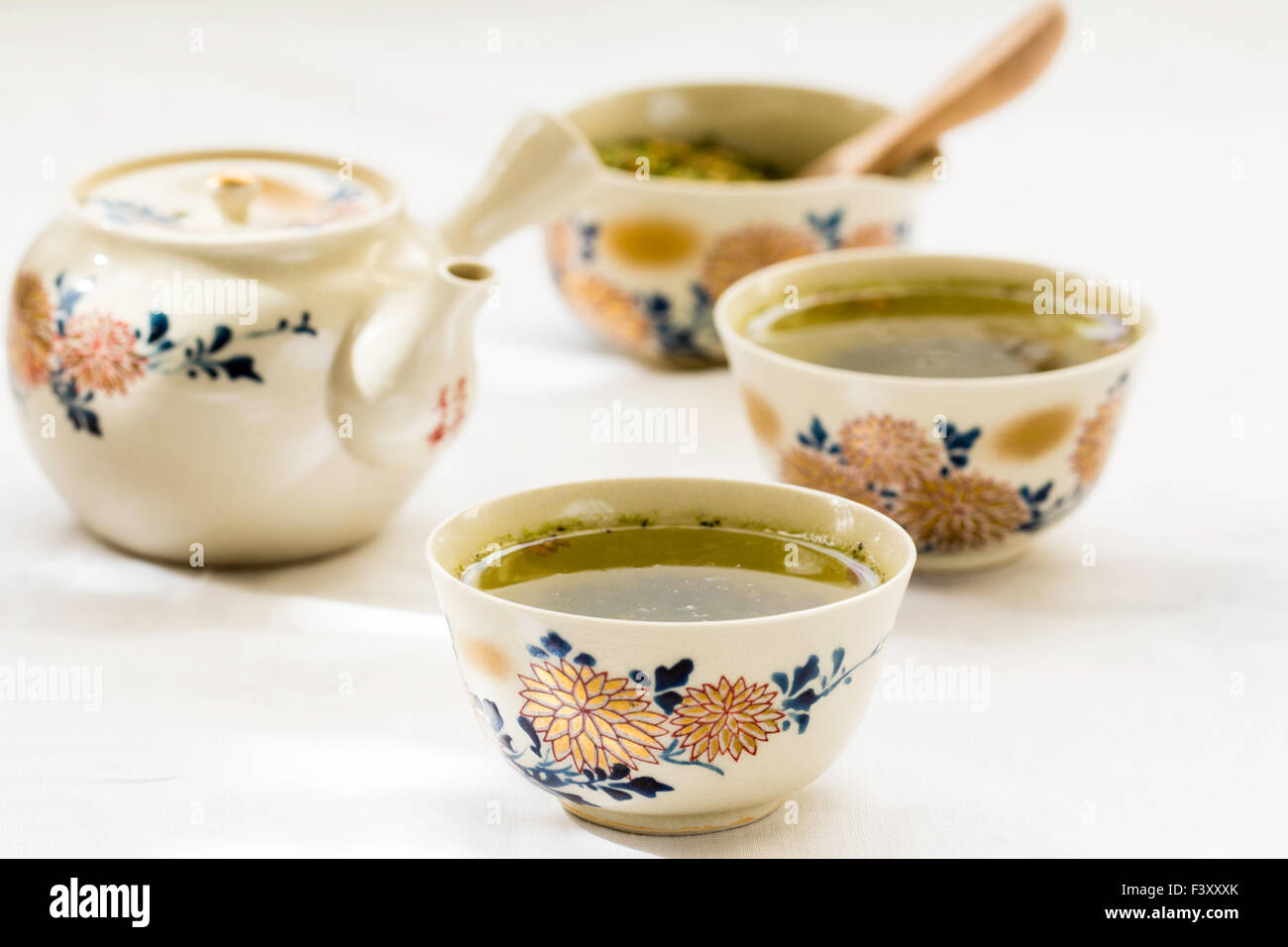 Japanese Chrysanthemum decorated tea set. Teapot, two handless cups ...