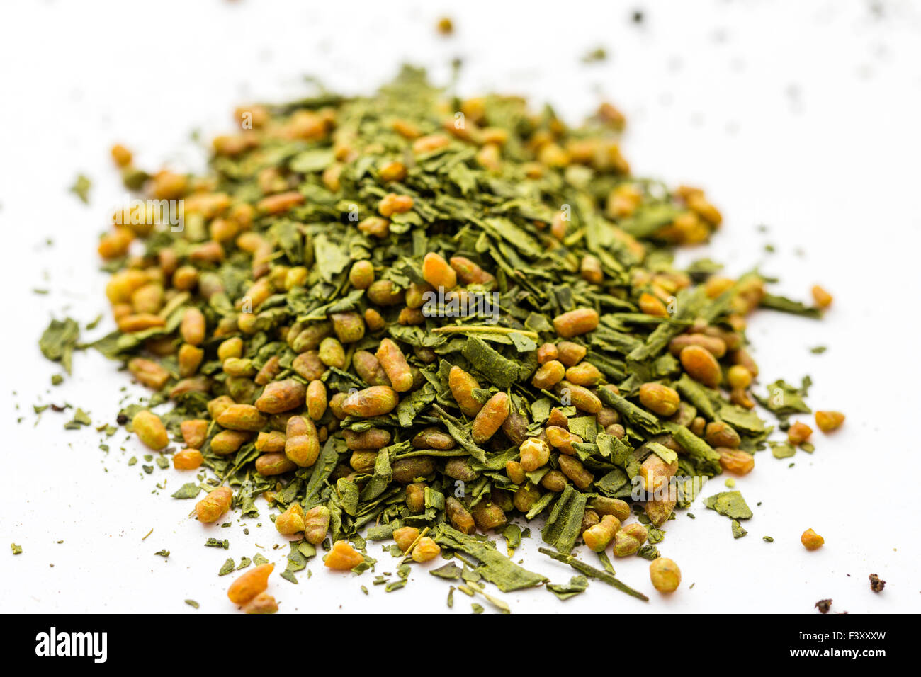 Small pile of Japanese Green tea brand known as "popcorn tea", on white ...
