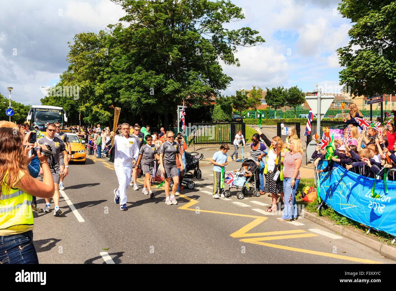 Ramsgate, UK. 2012 Olympics. The torch being carried along London Road ...