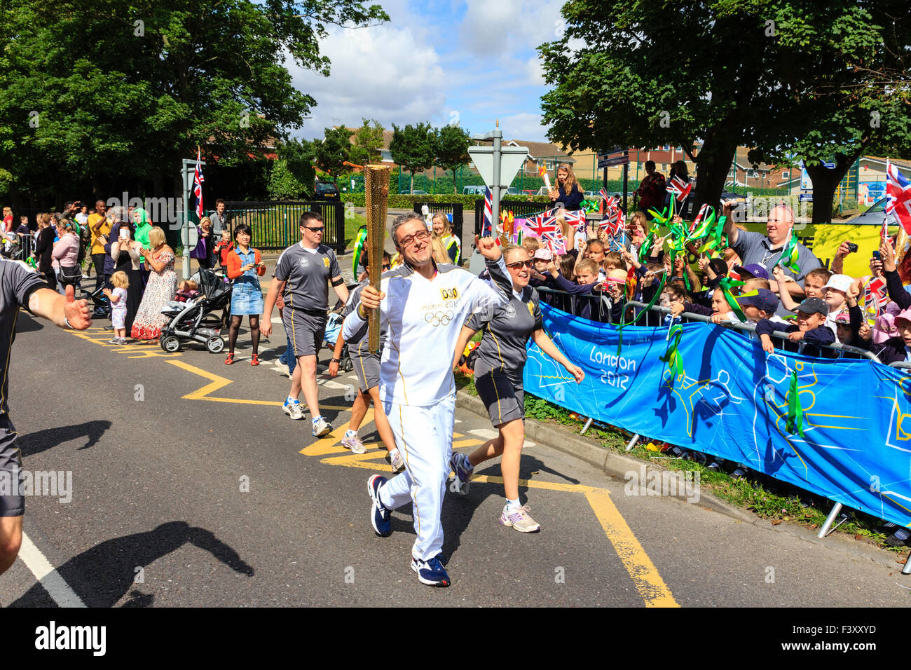 Ramsgate, UK. 2012 Olympics. The torch being carried along London Road ...