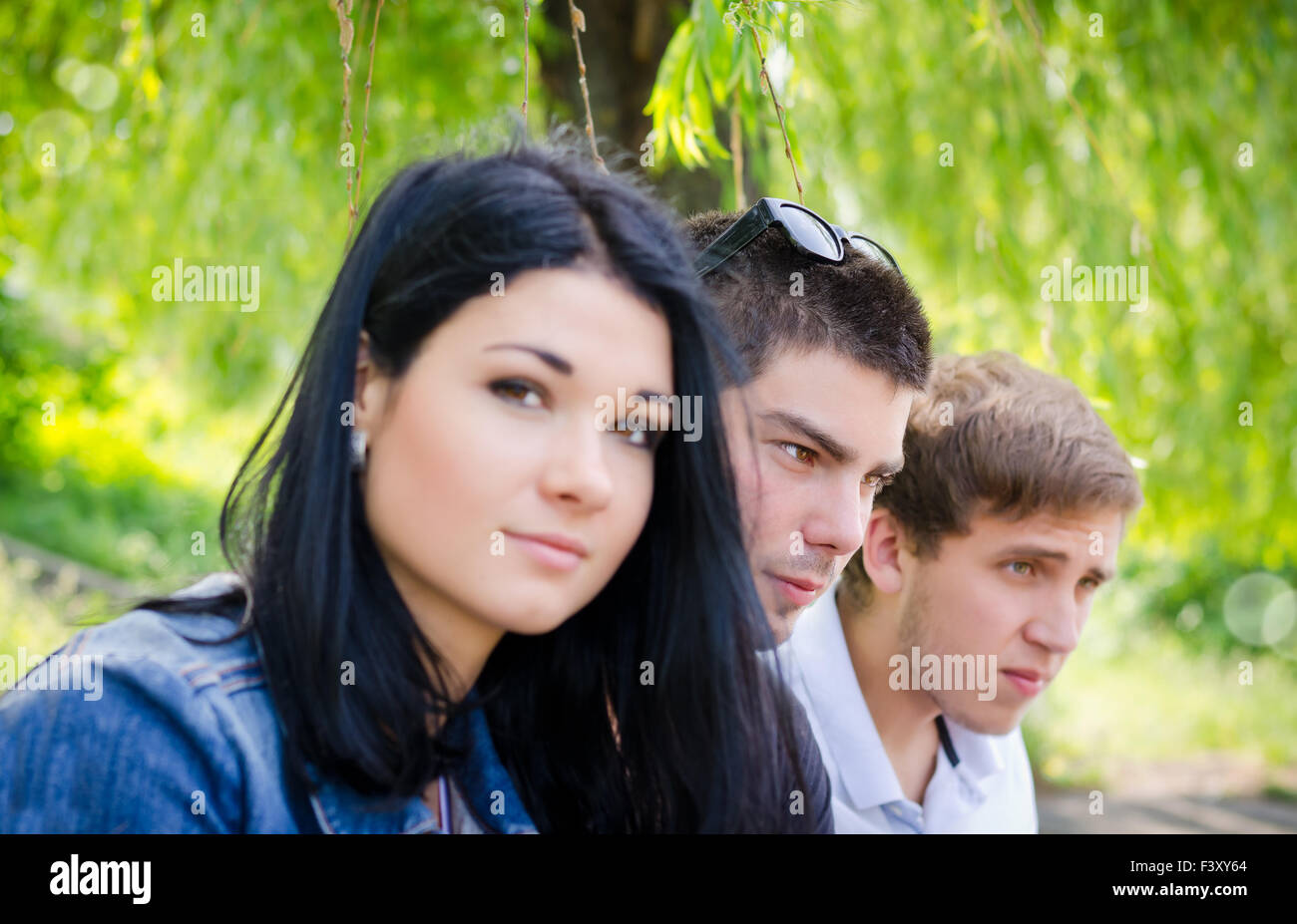Row of friends sitting together Stock Photo - Alamy