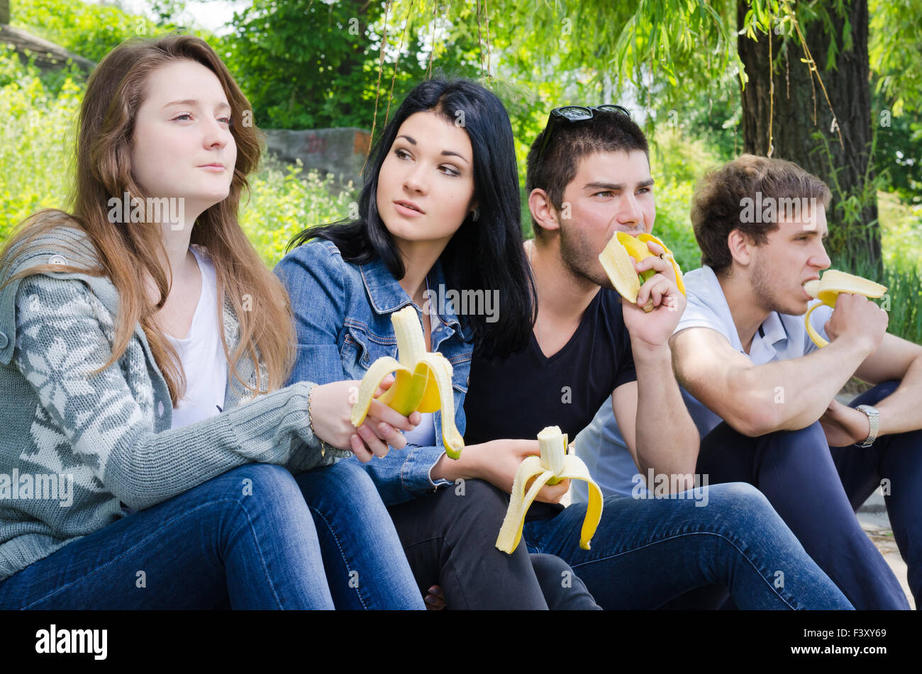 Row of friends sitting together Stock Photo - Alamy
