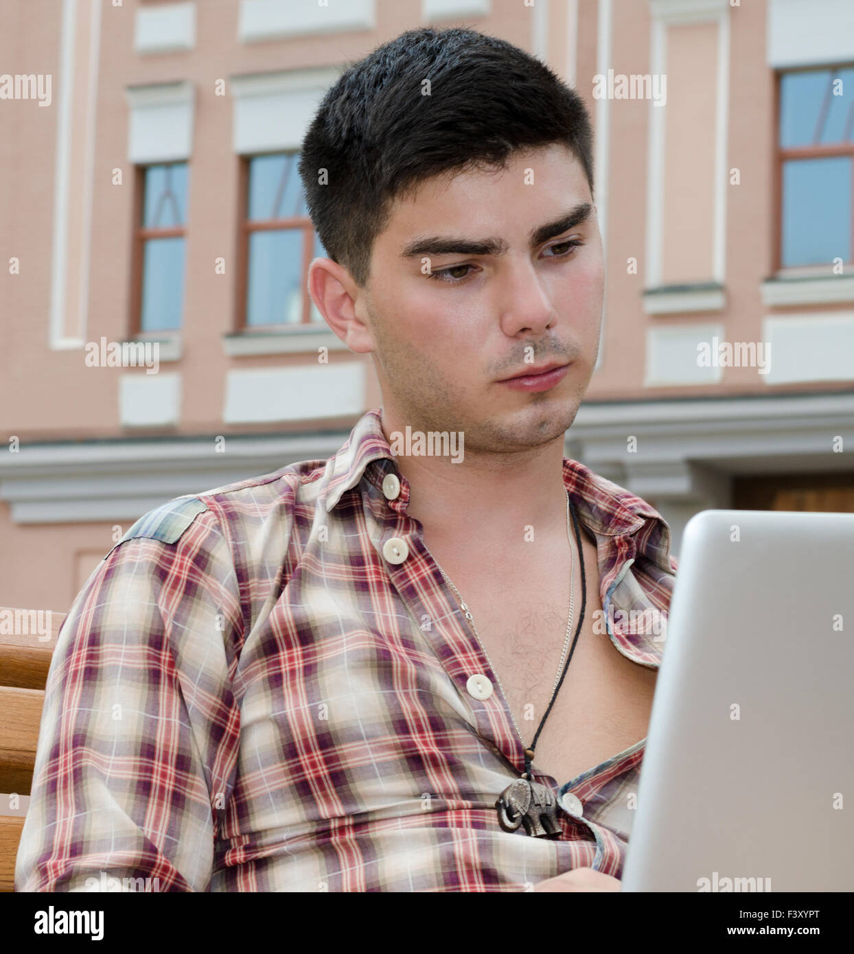 Young man using a laptop Stock Photo - Alamy