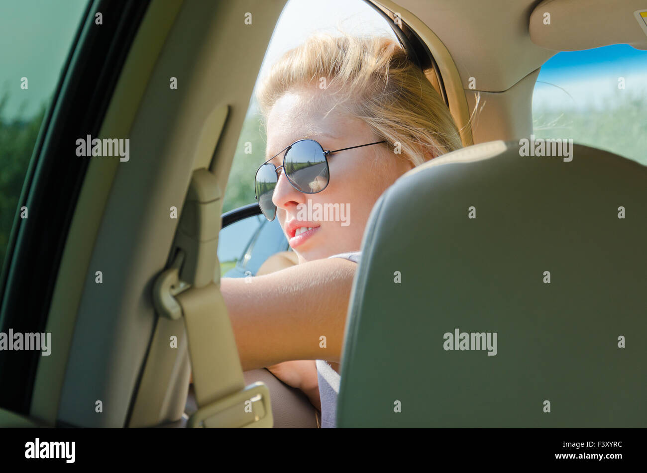 Woman looking out of a car window Stock Photo - Alamy