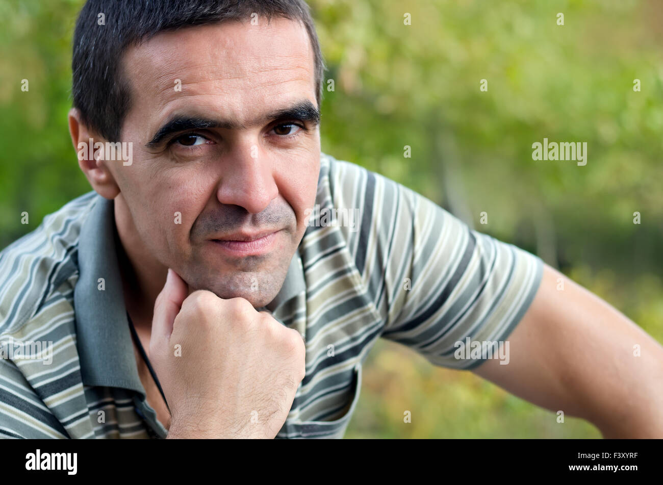 Attractive man sitting tinking Stock Photo - Alamy