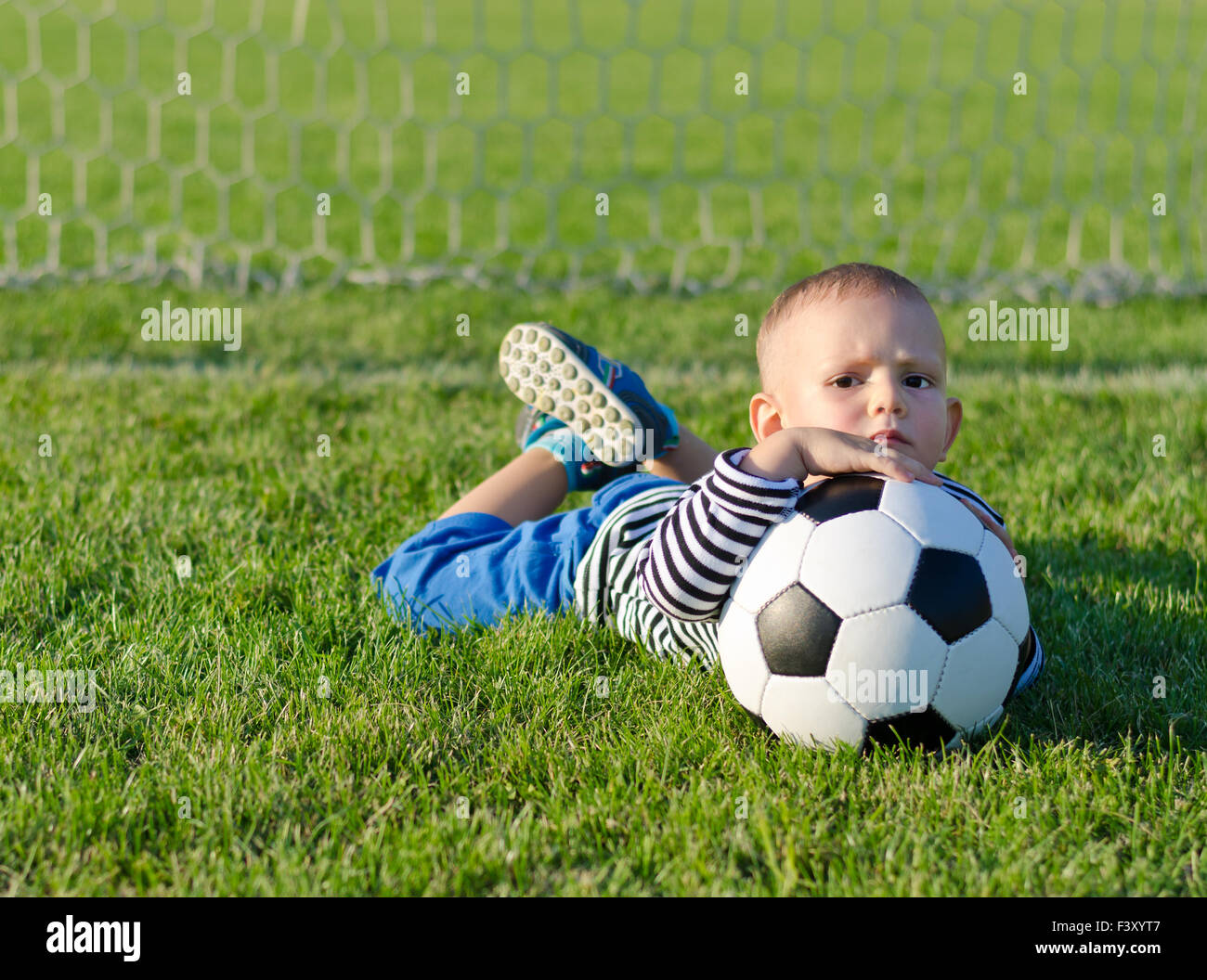 Boy lying on ground hi-res stock photography and images - Alamy