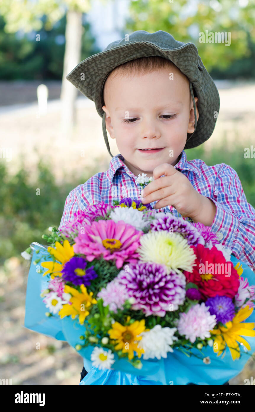 Boy taking a single flower from a bouquet Stock Photo - Alamy