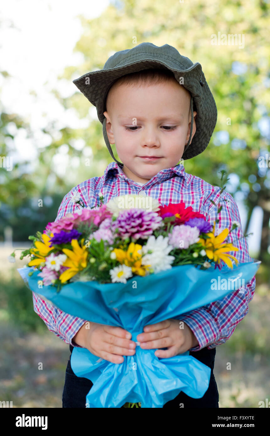Little boy with bunch of flowers Stock Photo - Alamy