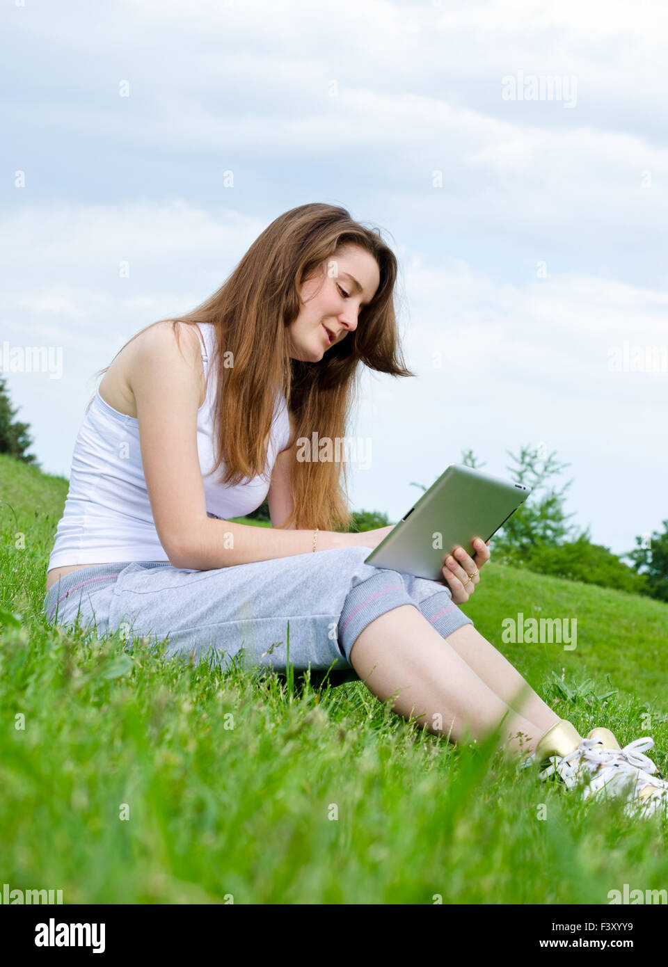 Smiling woman using touchscreen tablet Stock Photo - Alamy