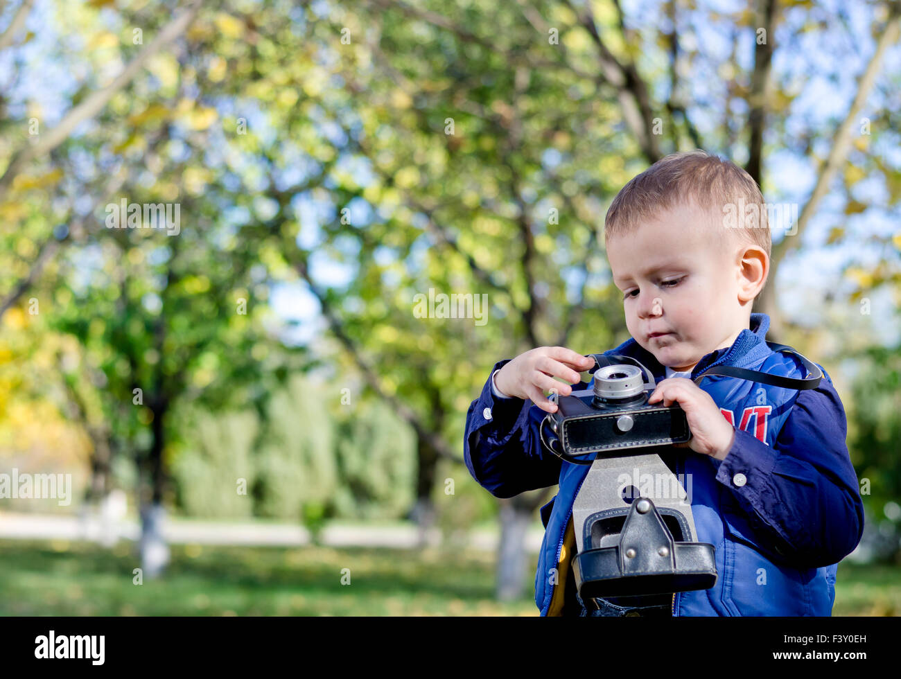 Little boy playing with a vintage camera Stock Photo - Alamy