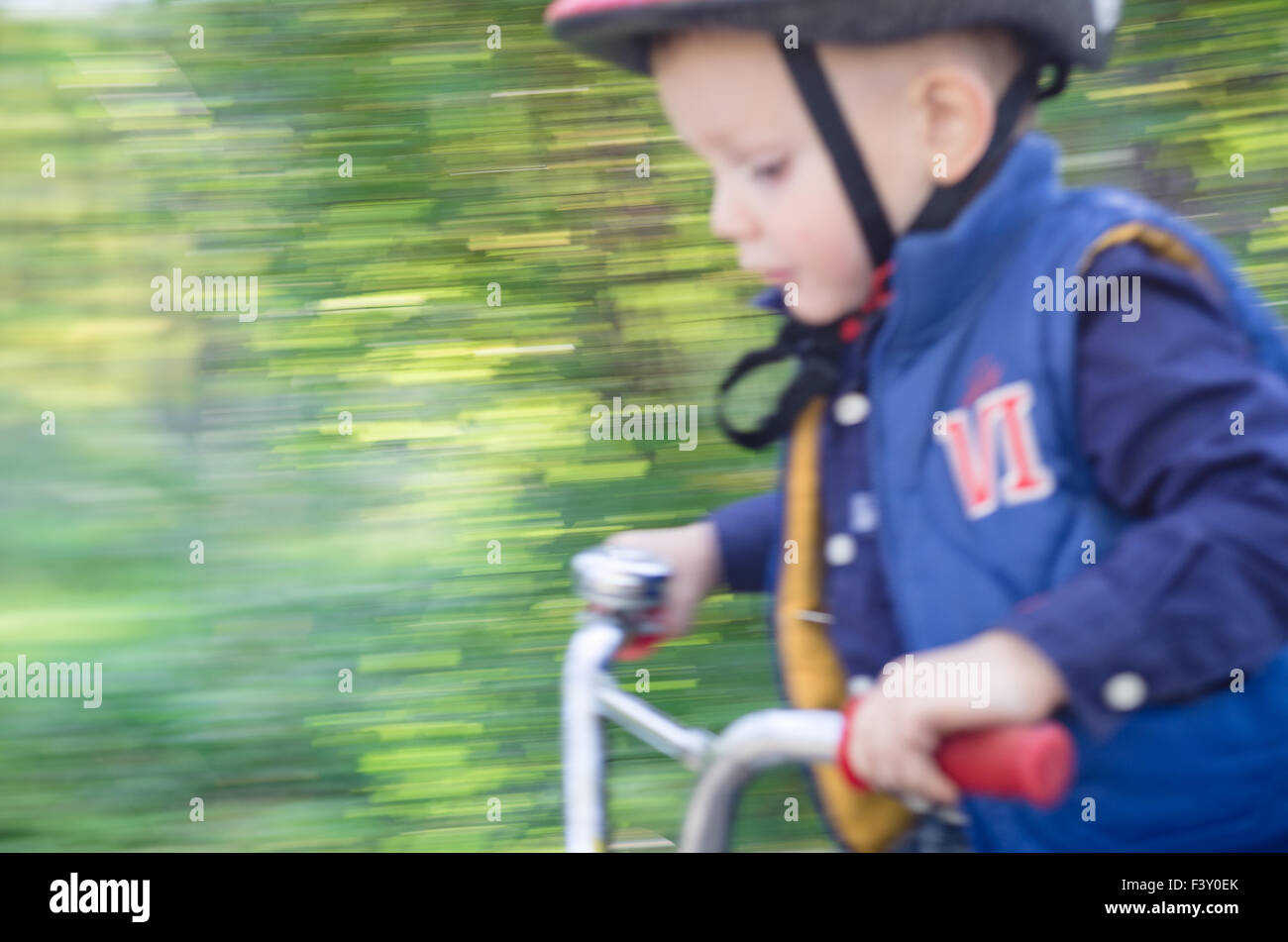 Small boy riding a bicycle Stock Photo - Alamy
