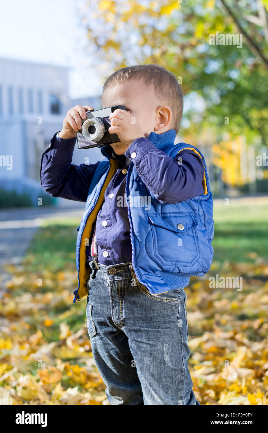 Cute little boy with retro camera Stock Photo - Alamy