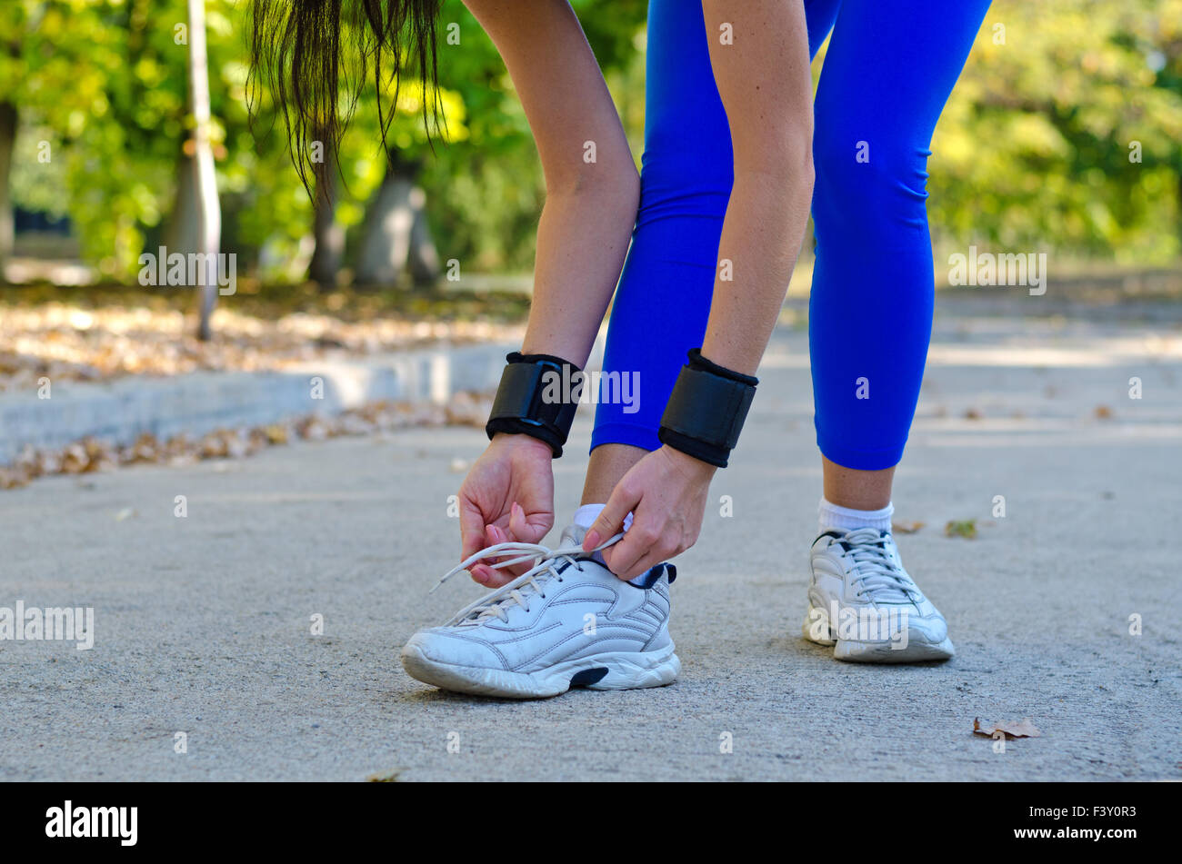 Woman tying trainers hi-res stock photography and images - Alamy