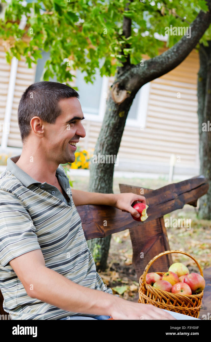 Laughing man enjoying an apple Stock Photo - Alamy