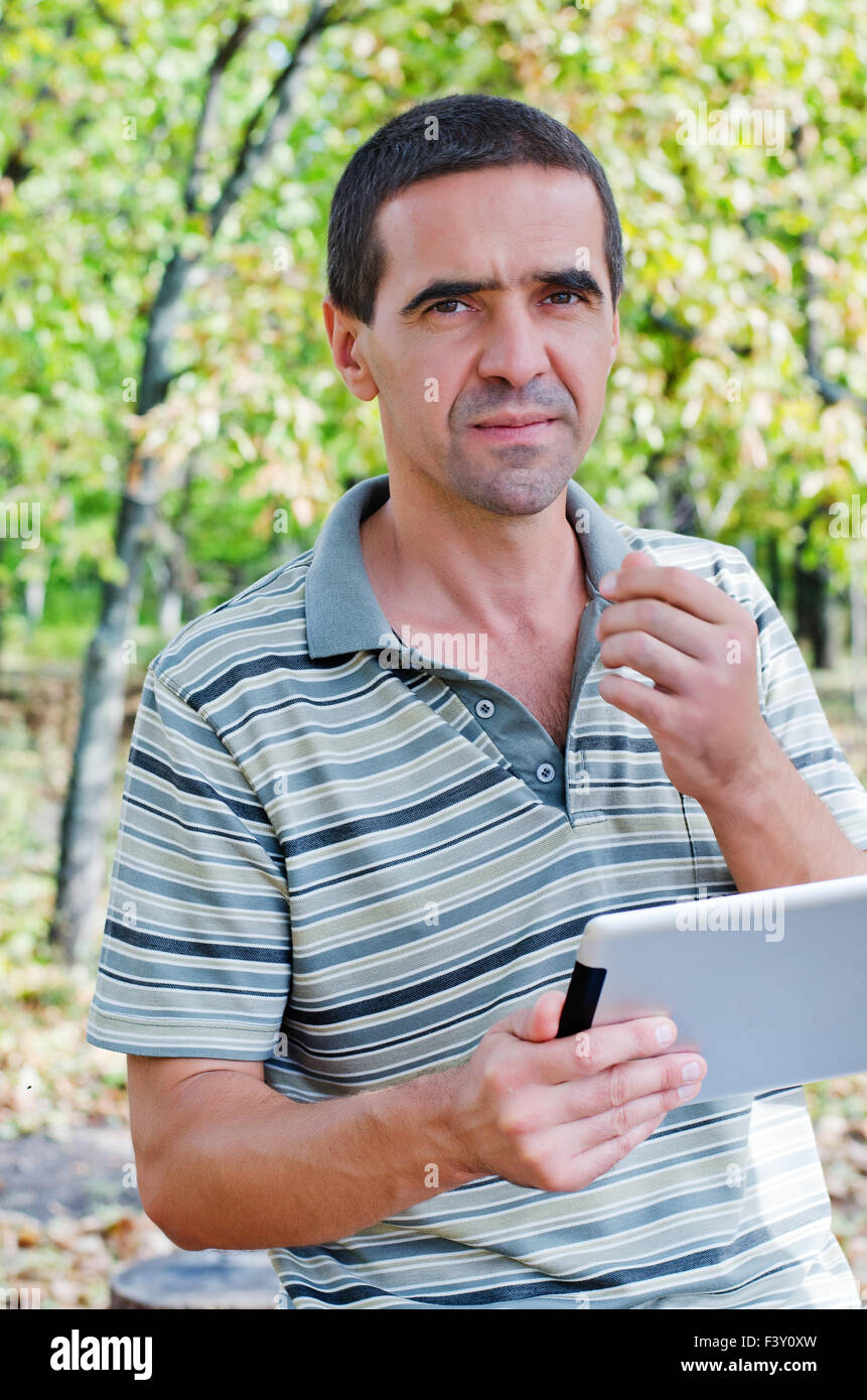 Serious man using a tablet Stock Photo - Alamy Serious man using a tablet Stock Photo - Alamy