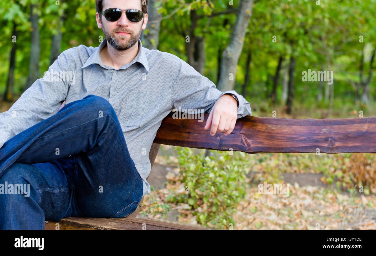 Man resting on a bench Stock Photo - Alamy
