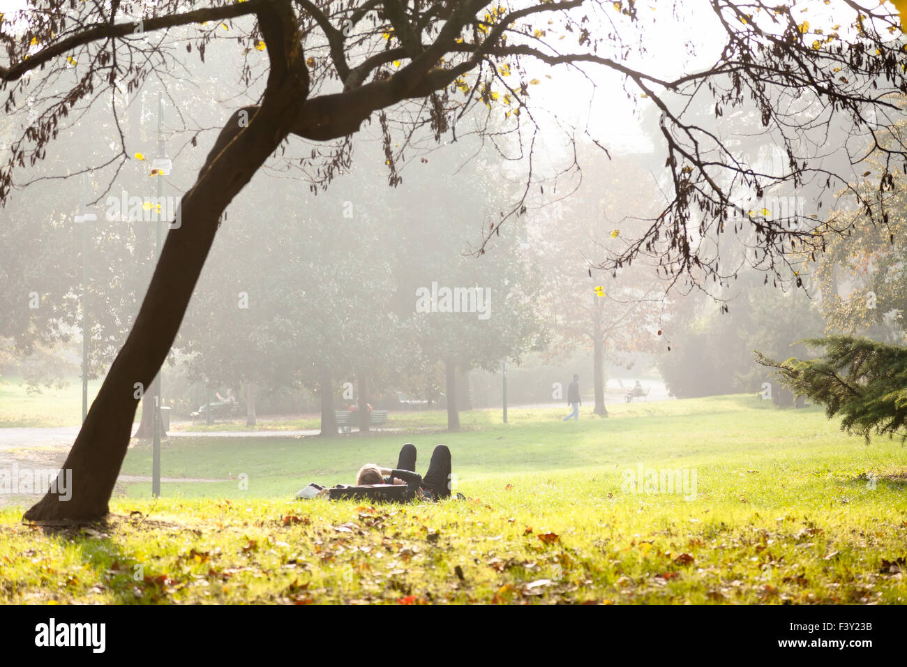 Young man lying on the grass Stock Photo - Alamy