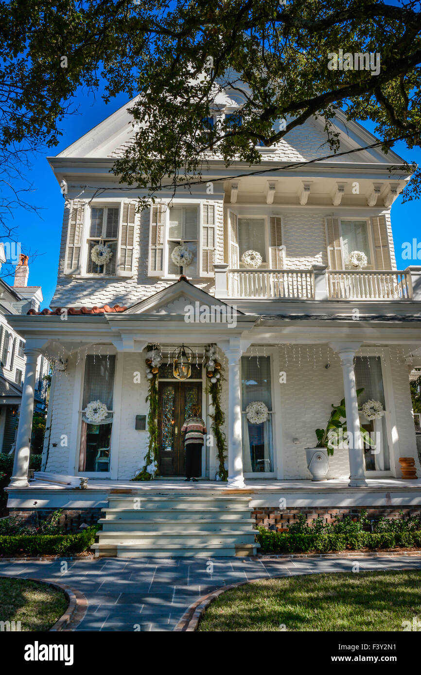 A visitor at the door of a classic Garden District mansion, decorated ...