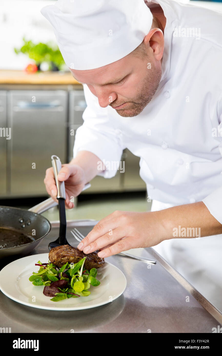 Professional chef prepare meat dish at restaurant Stock Photo - Alamy