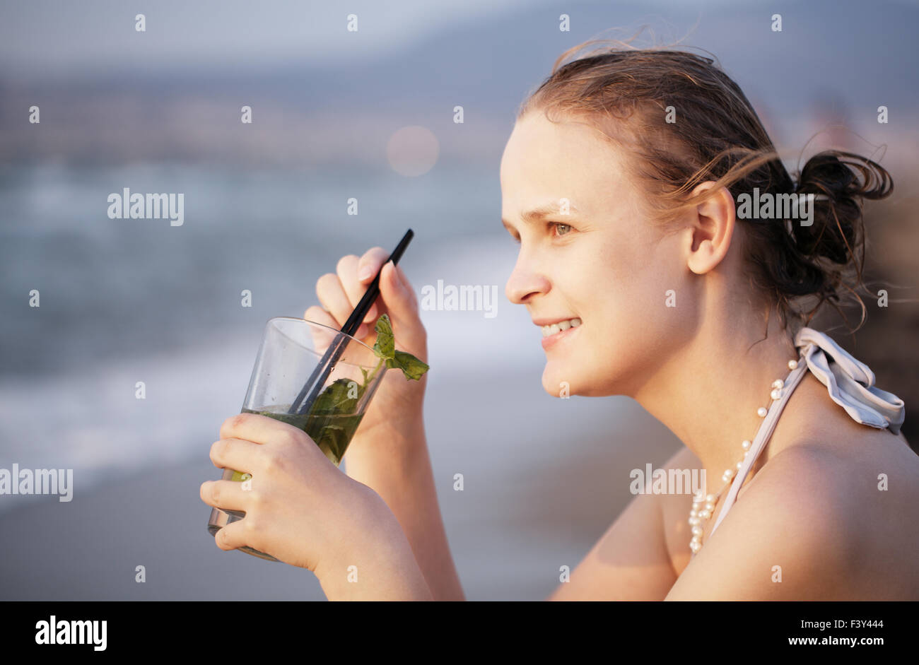 Woman enjoying an evening cocktail Stock Photo - Alamy
