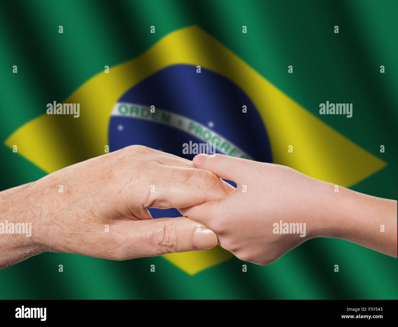 Two hands and Brazilian flag Stock Photo - Alamy