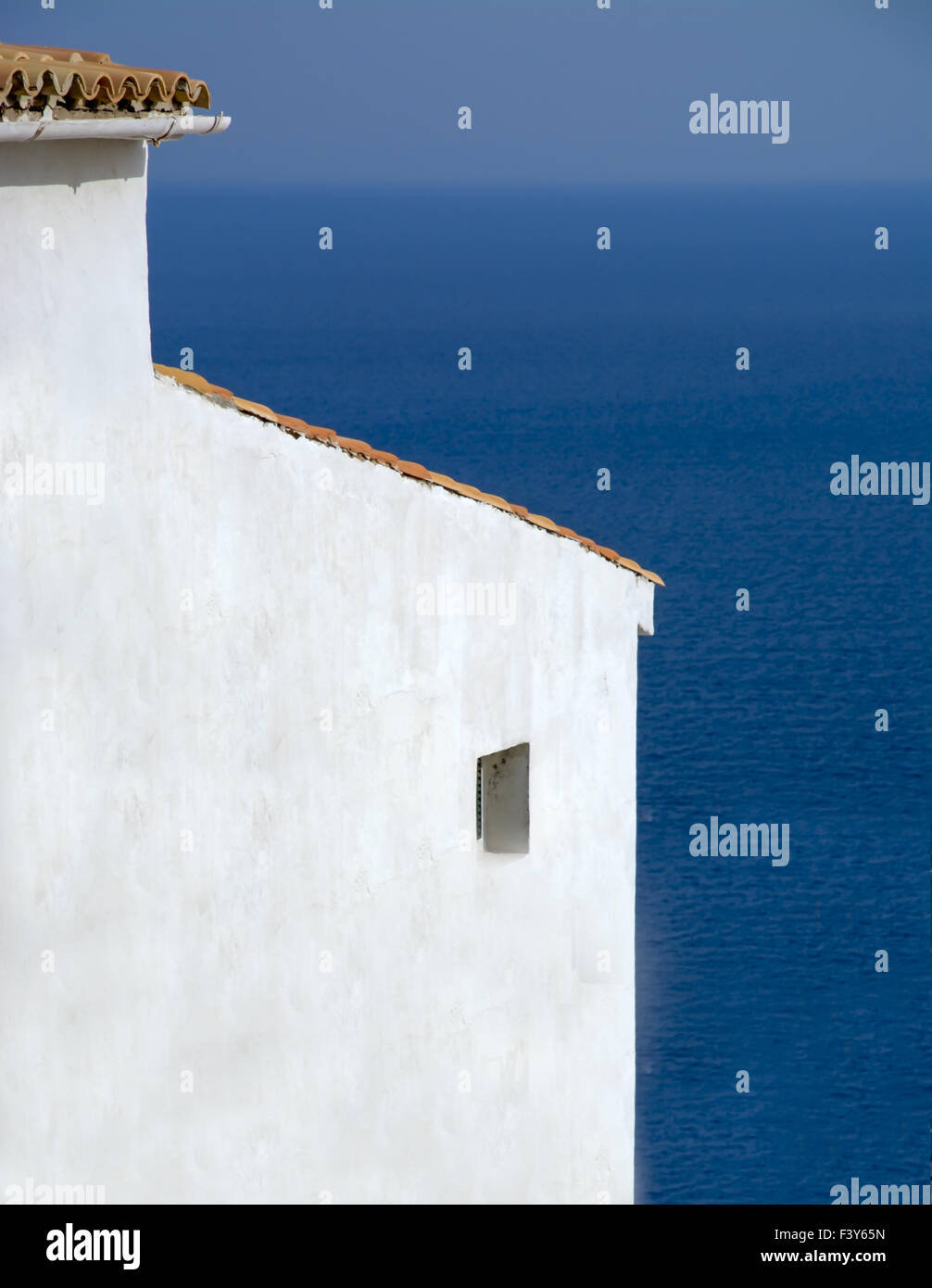White building by blue sea Stock Photo - Alamy
