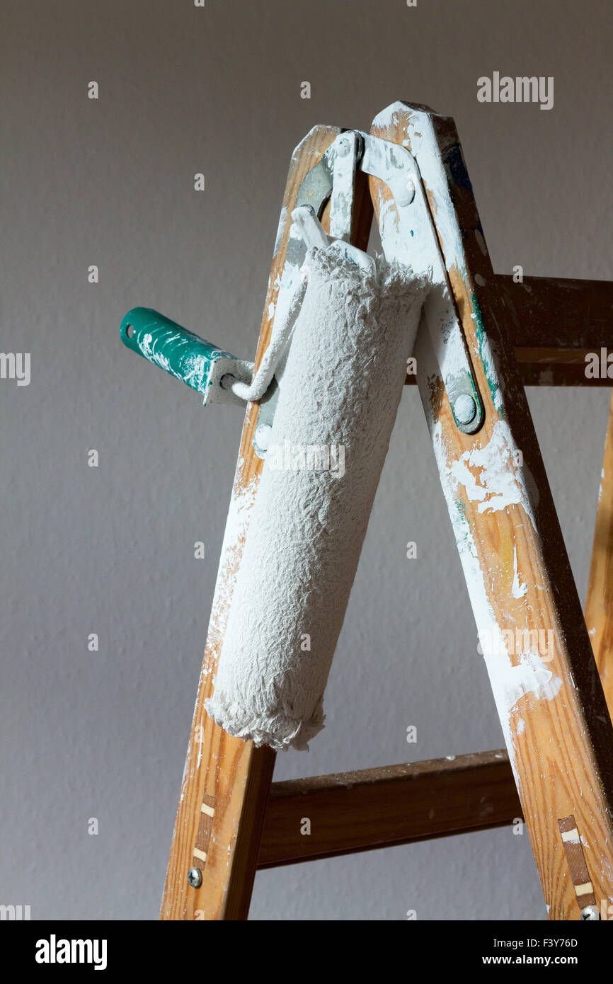 Woman on ladder painting wall hi-res stock photography and images - Alamy