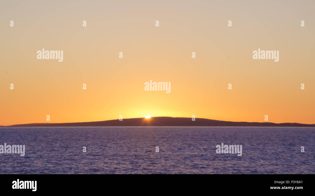 Sun Setting On Island Stock Photo - Alamy