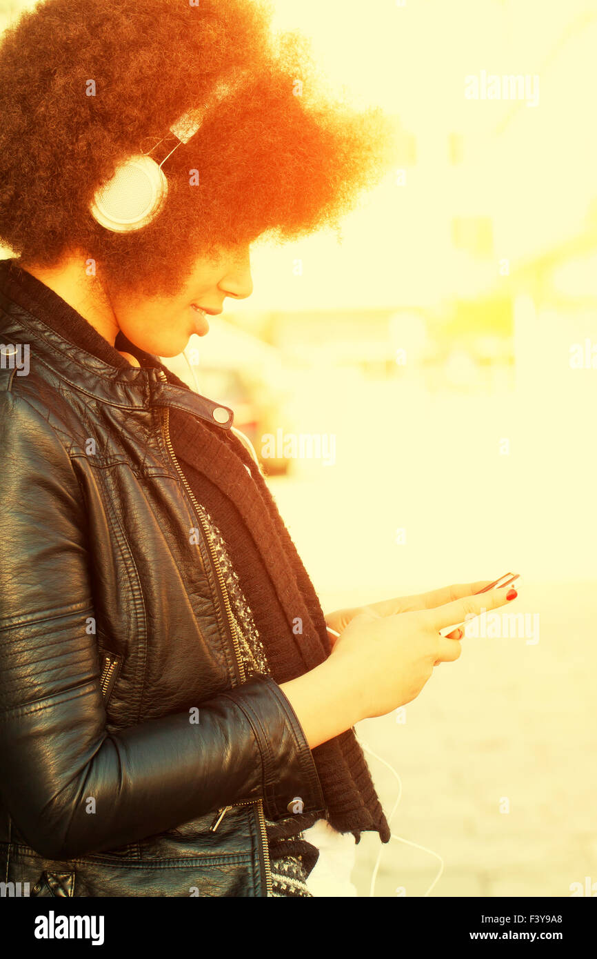 Young, black woman listen music in the sun Stock Photo - Alamy
