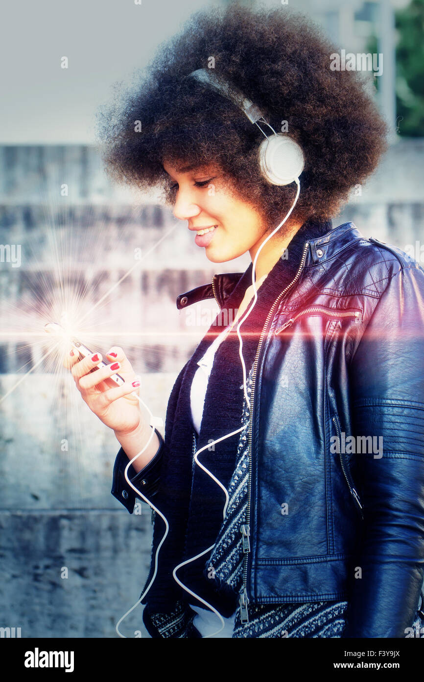 Young, black woman listen music with smartphone Stock Photo - Alamy