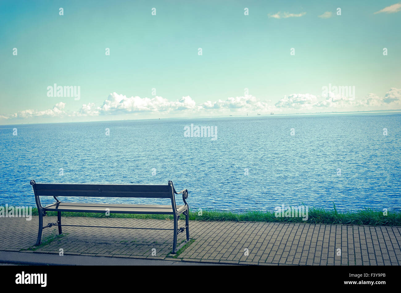 The lonely a bench on the seafront Stock Photo - Alamy
