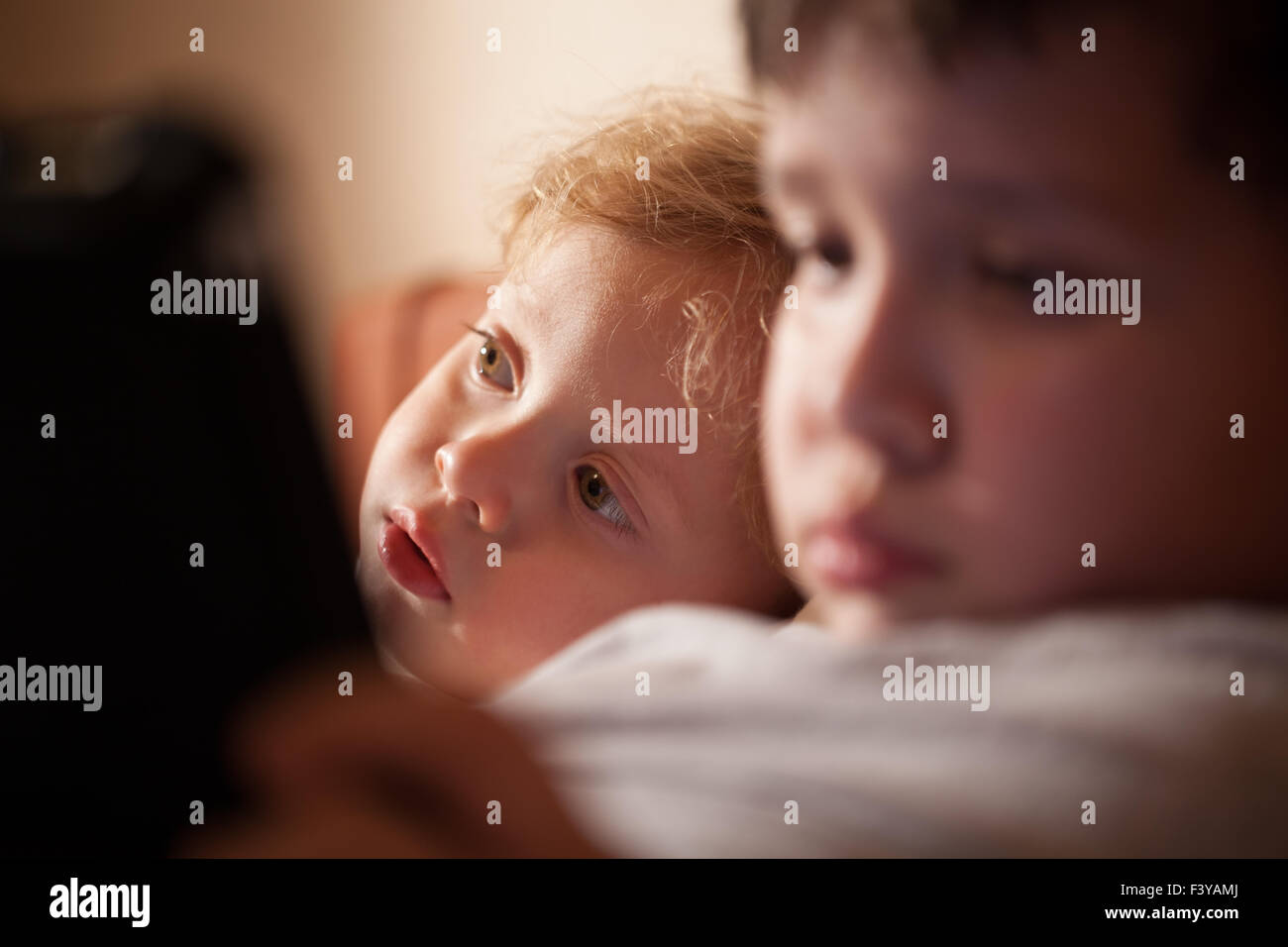 Cute young child relaxing with his brother Stock Photo - Alamy