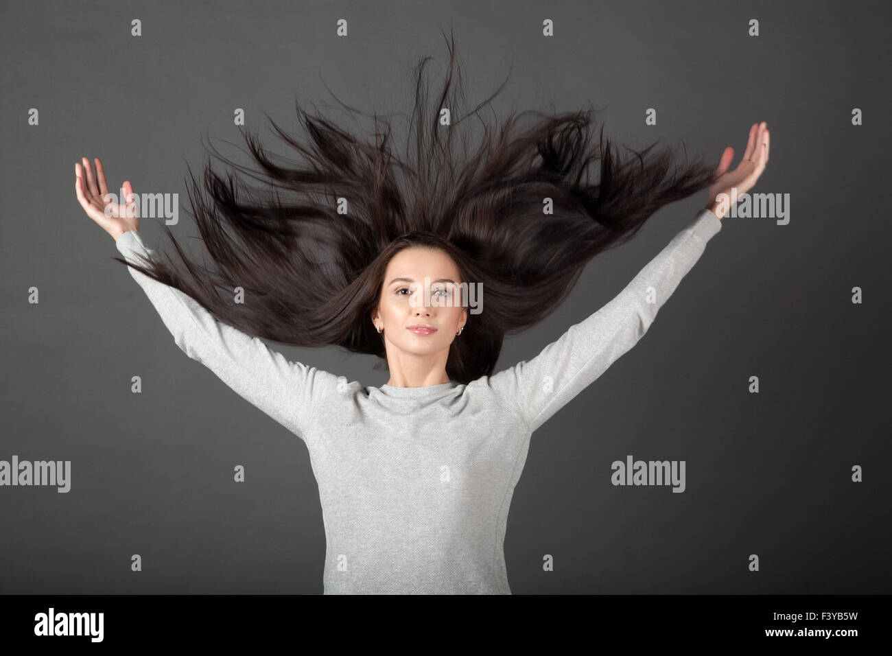 Woman on a gray background Stock Photo - Alamy