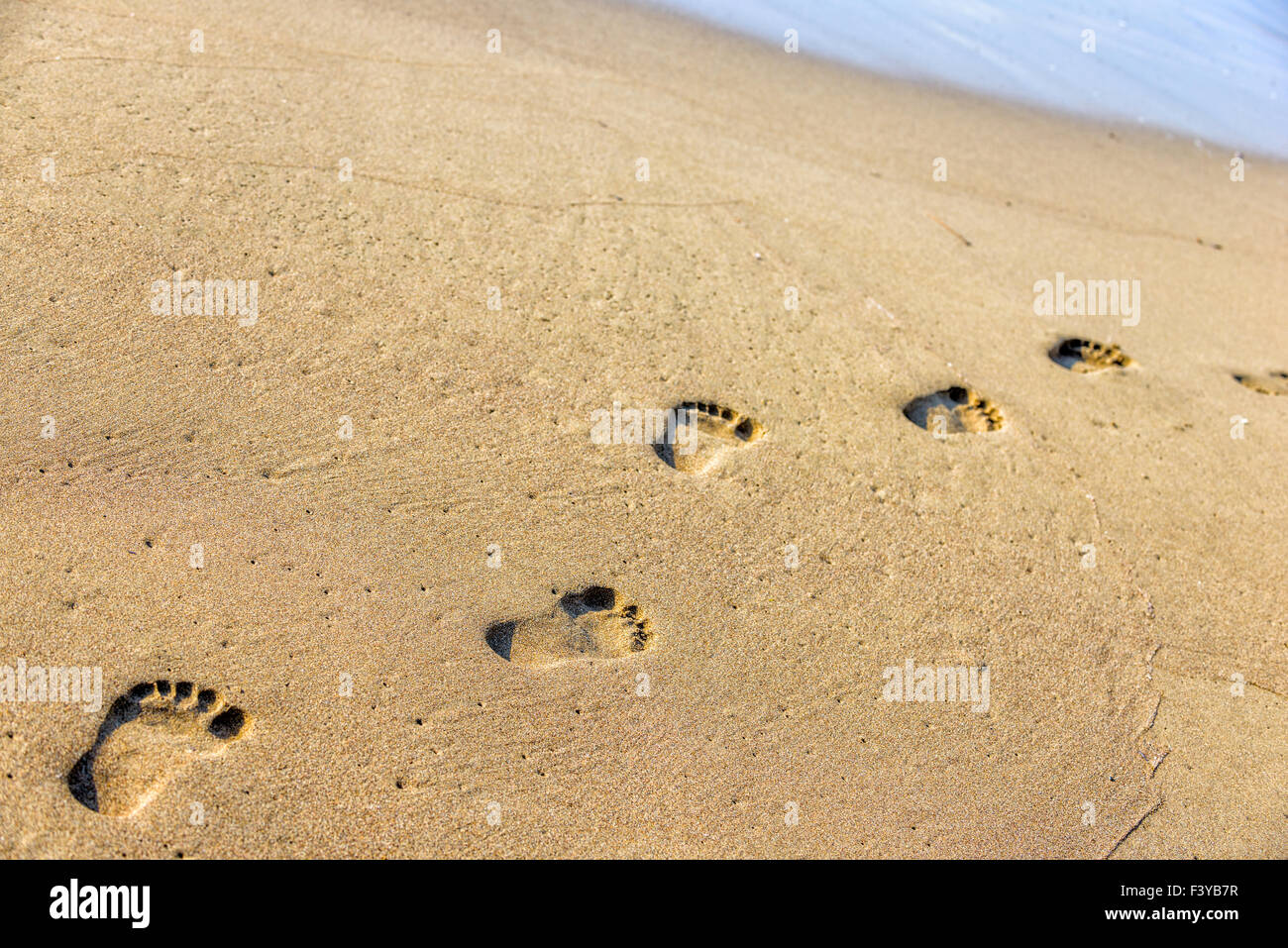 Footsteps on the sand Stock Photo - Alamy