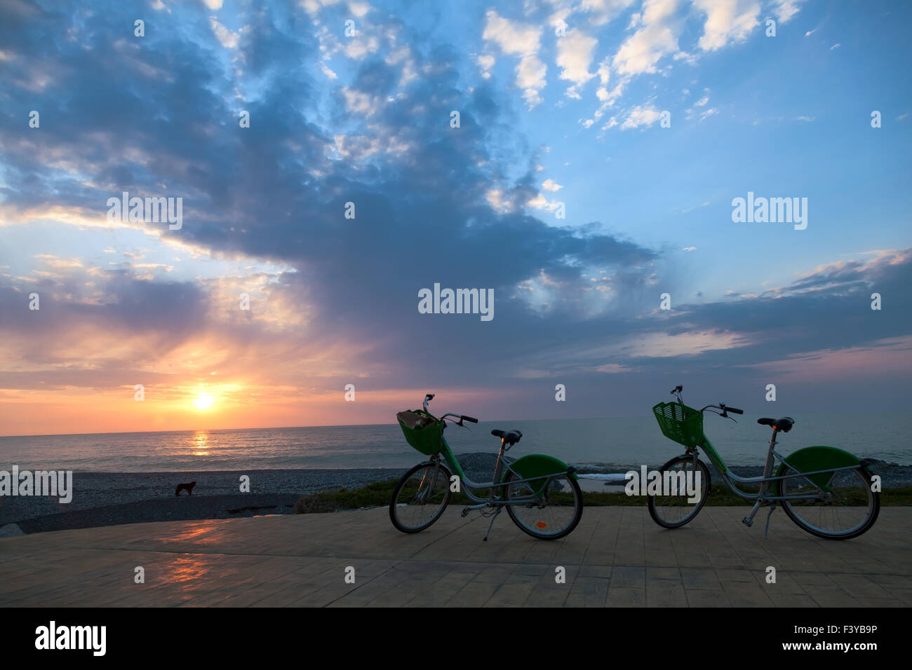 Two bicycles at sunset Stock Photo - Alamy