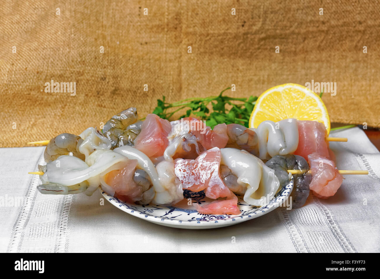 Skewers of sea foods with shrimps and squid Stock Photo - Alamy