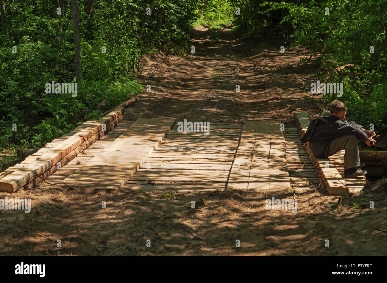 Wooden bridge over small river Stock Photo - Alamy