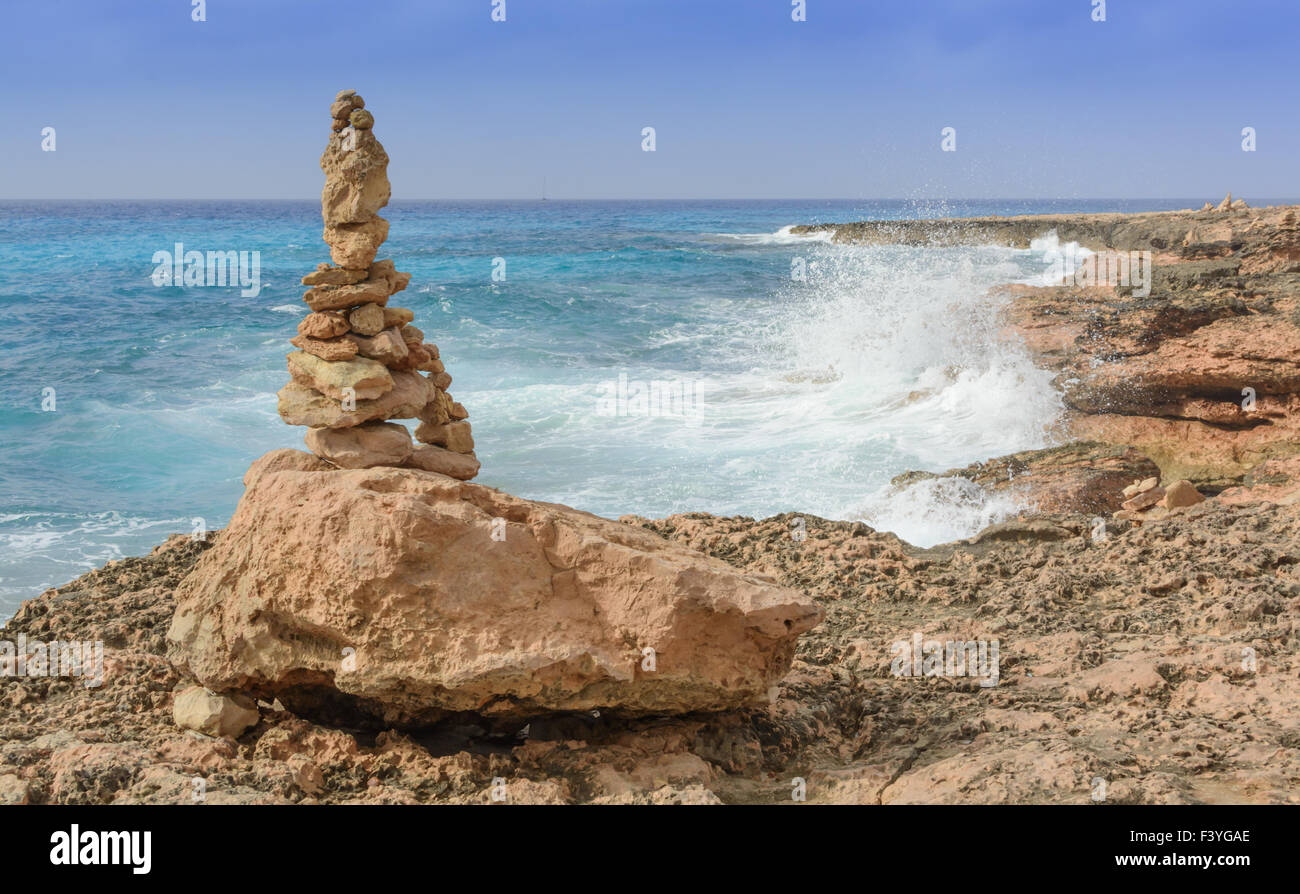 Rock tower and splashing waves Stock Photo - Alamy