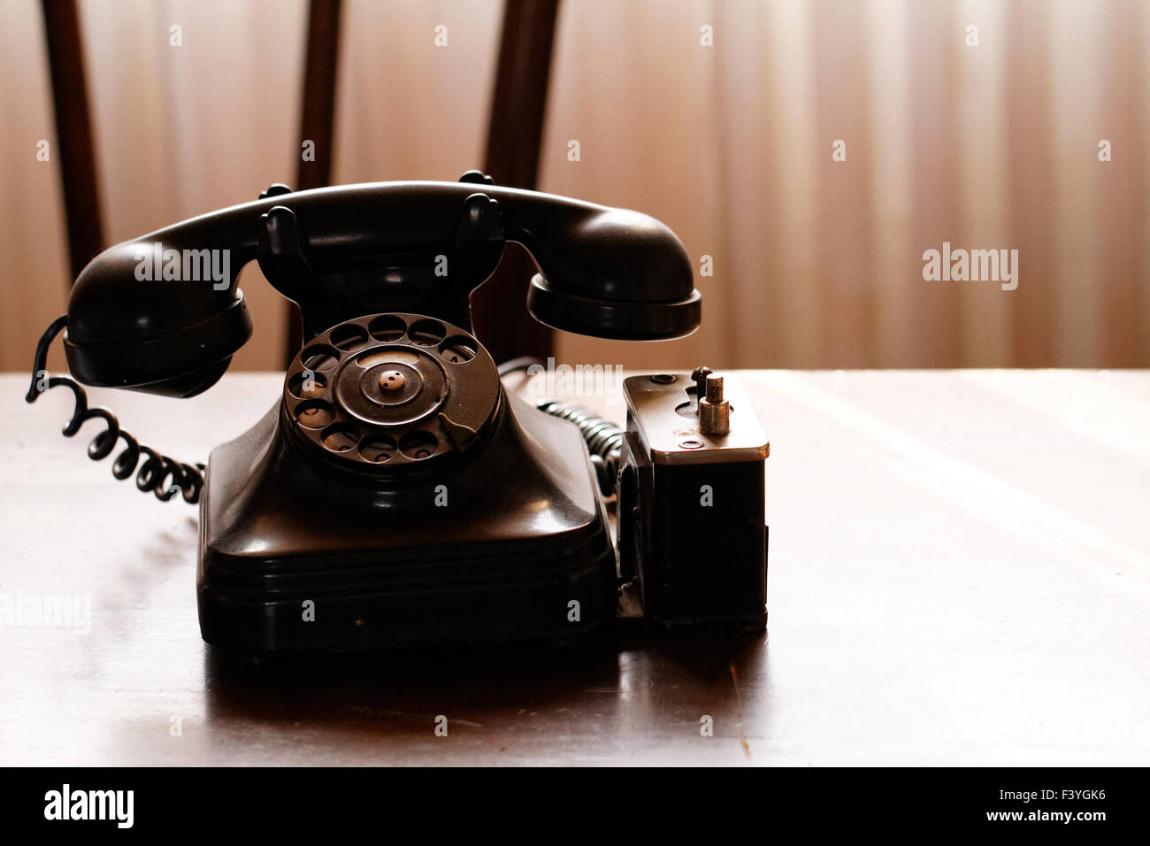 Photo of an old black wired phone Stock Photo - Alamy