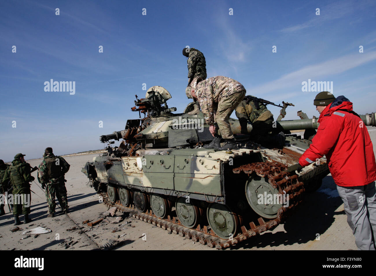 Donetsk, Ukraine. 13th Oct, 2015. People search on a destroyed tank on ...