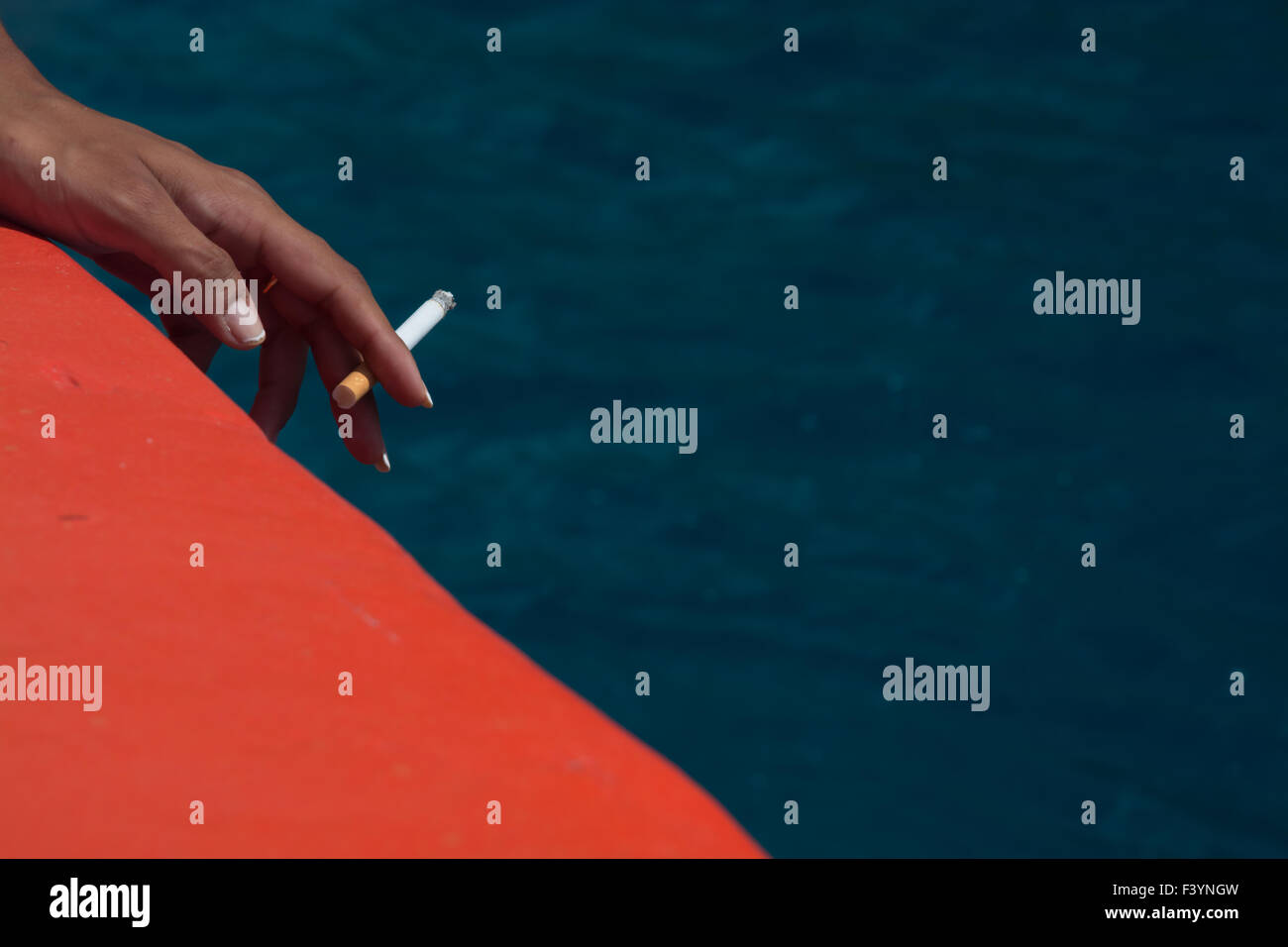 Cigarette in hand Stock Photo - Alamy