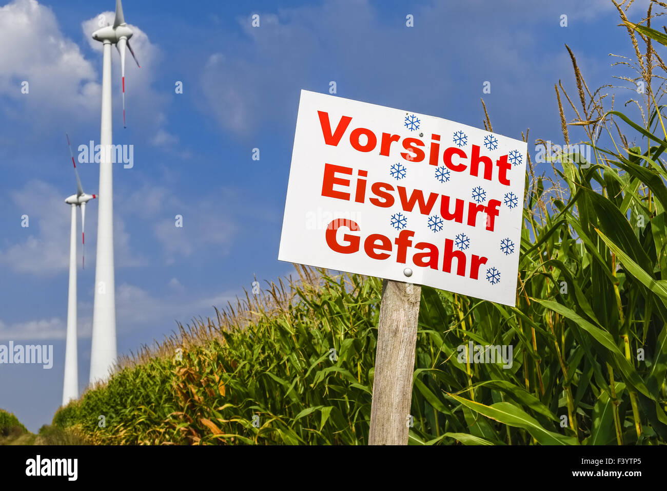 Danger sign in front of wind turbines Stock Photo - Alamy