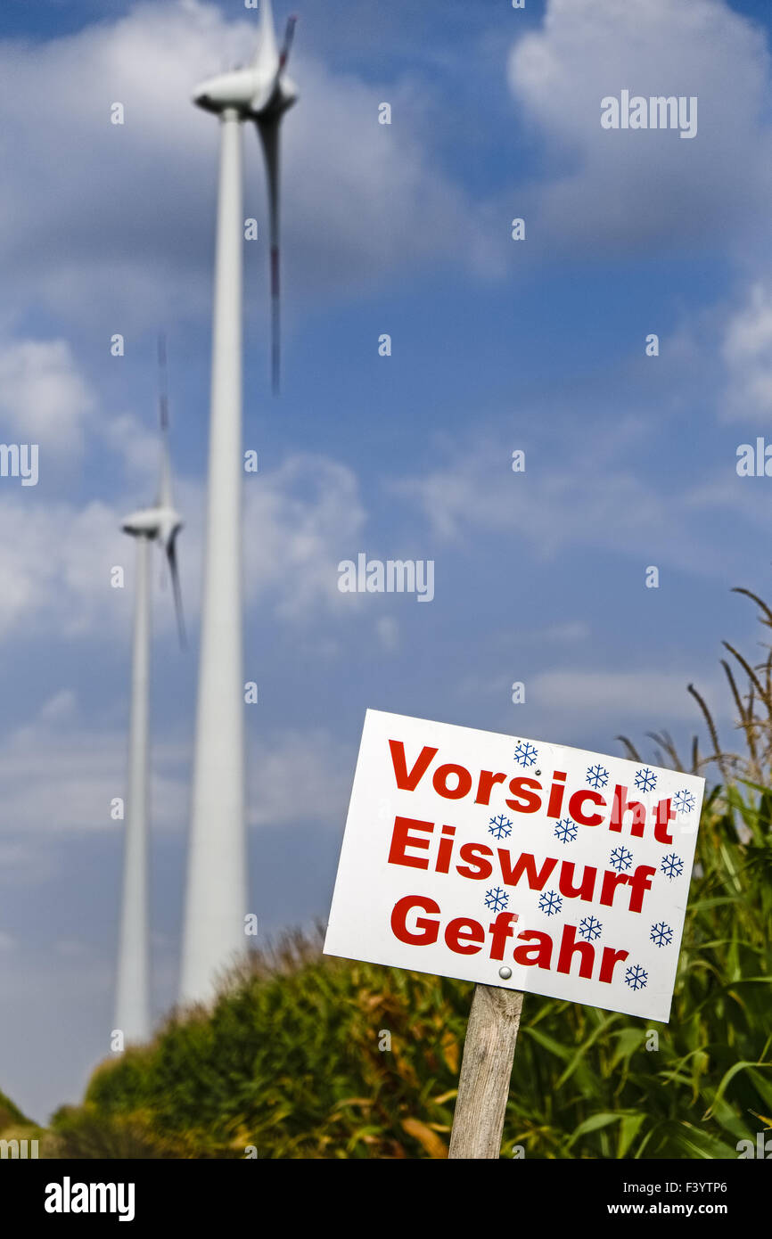 Danger sign in front of wind turbines Stock Photo - Alamy