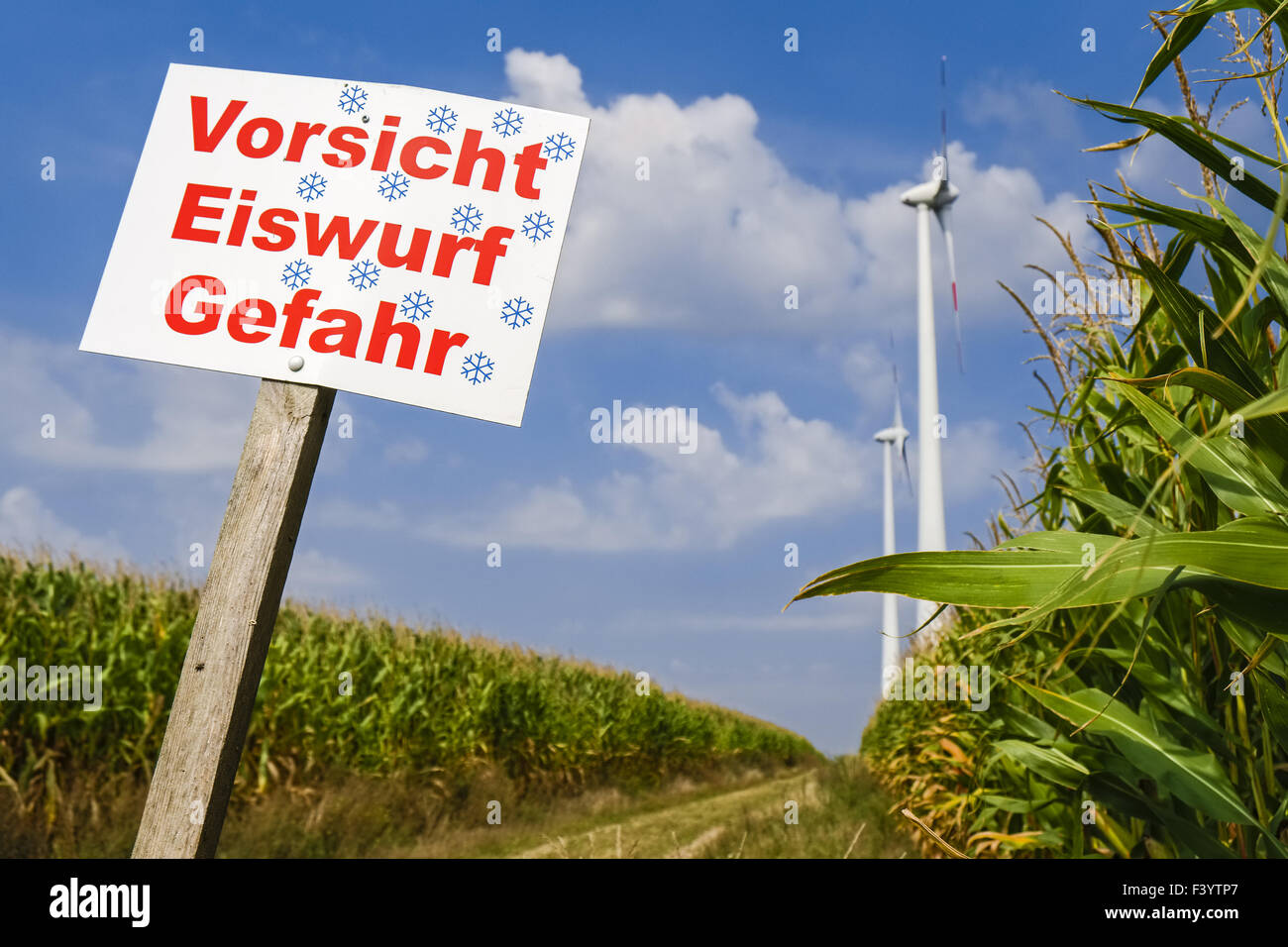Danger sign in front of wind turbines Stock Photo - Alamy