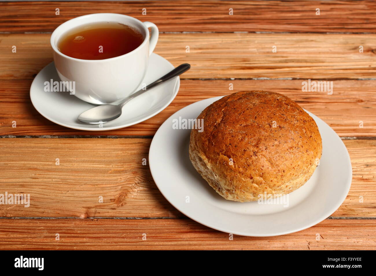 Graham Bread Roll and Tea Cup Stock Photo - Alamy