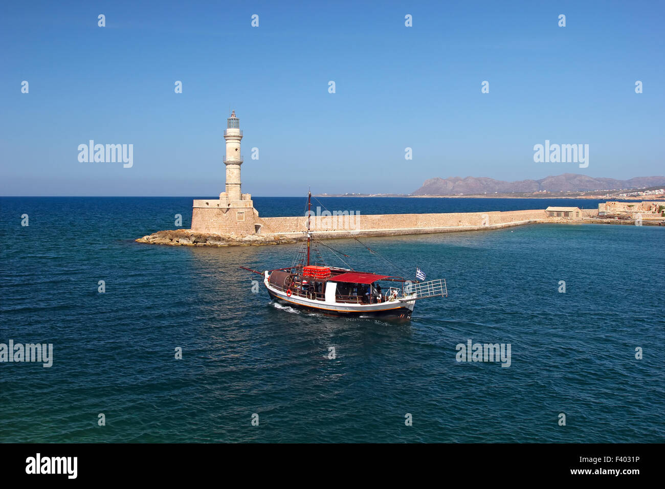 Lighthouse and a boat Stock Photo - Alamy