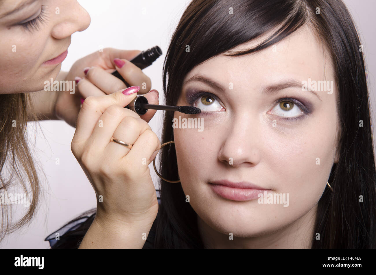 Makeup artist colors eyelashes model Stock Photo - Alamy